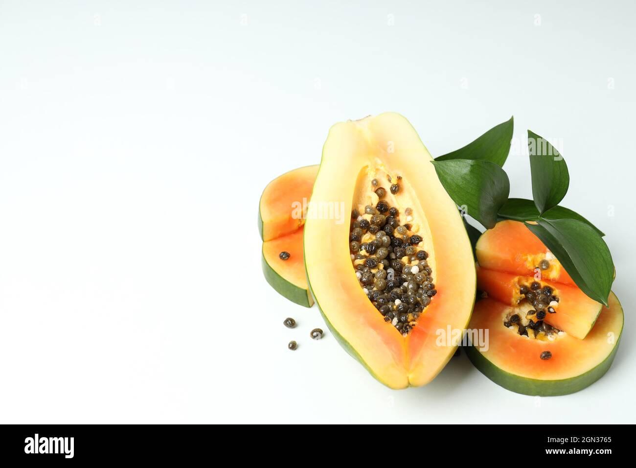 Fresh ripe papaya with leaves on white background Stock Photo - Alamy