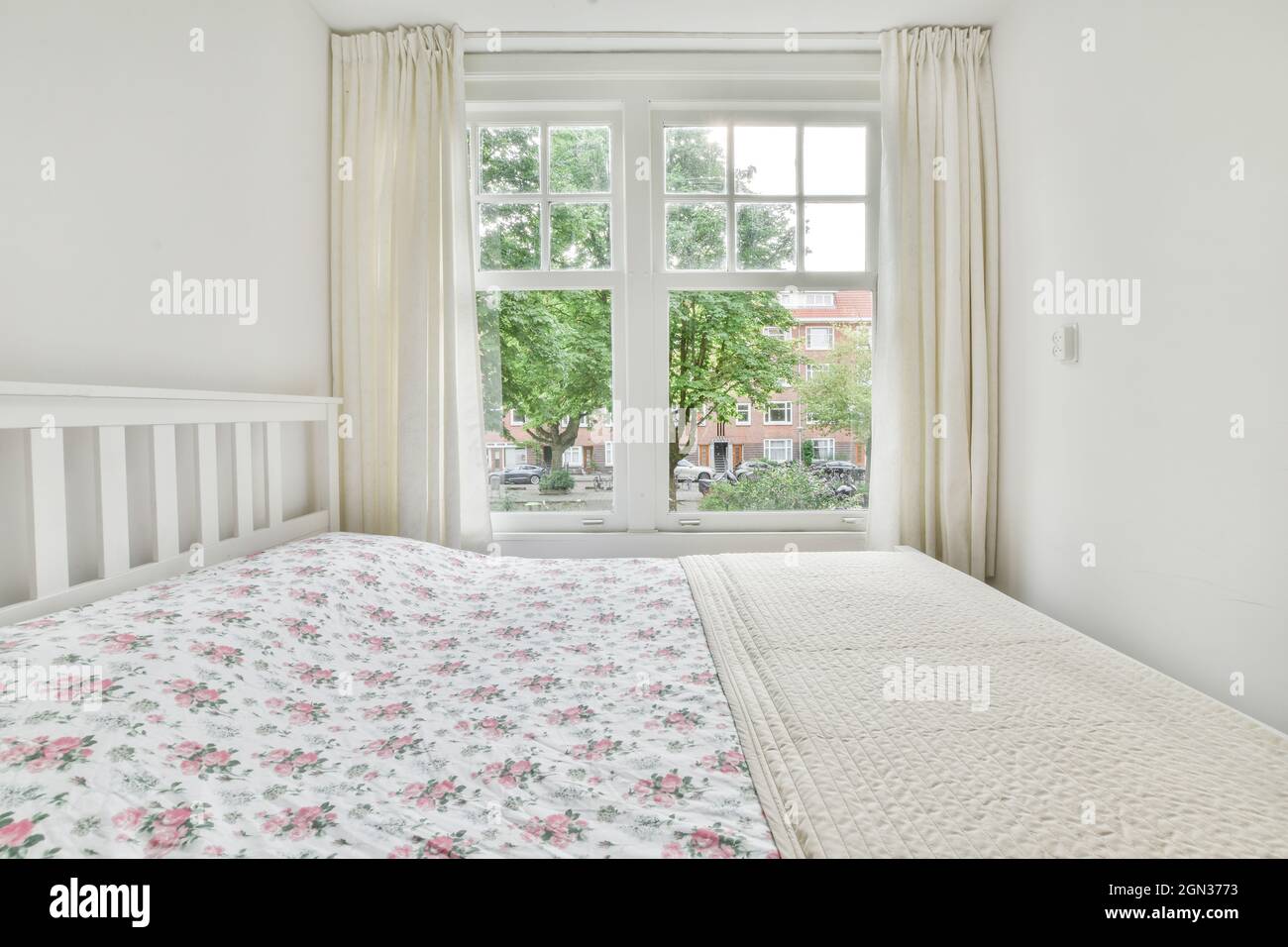 Minimalistic interior of bedroom with comfortable bed against window ...