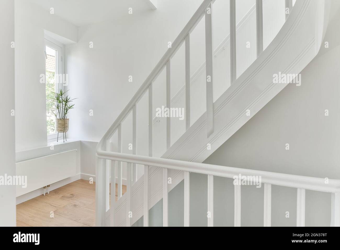 Wooden white railing of stairway in big private house with light ...