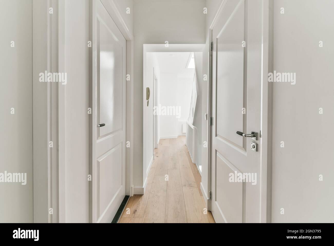 Interior of hallway with white doors in modern big house with parquet ...