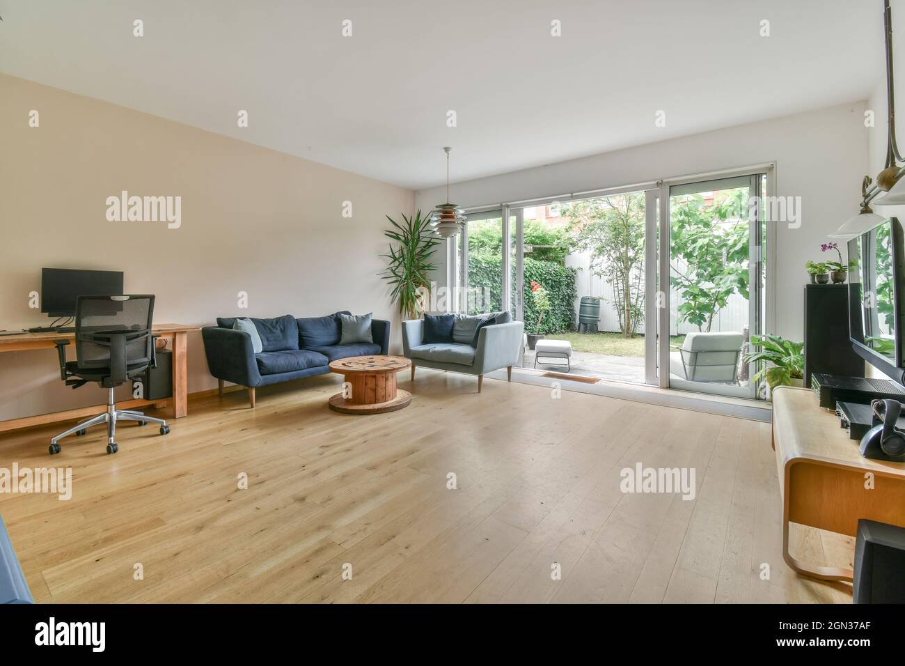 Interior design of spacious living room with sofa and TV set hanging ...