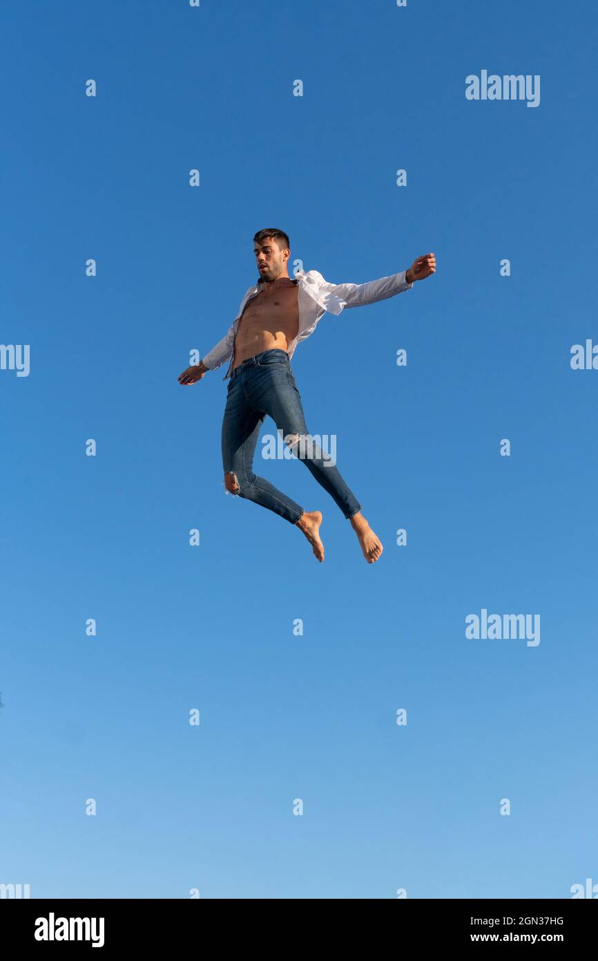 From below side view of energetic sportsman in trendy wear performing ...