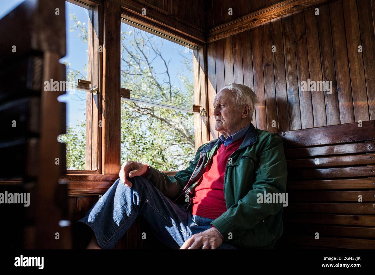 Attractive man and old man traveling in an old wooden train carriage ...