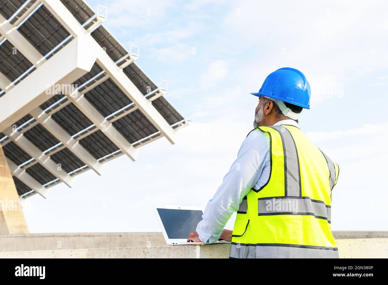 Anonymous male supervisor in uniform working on netbook sitting near ...