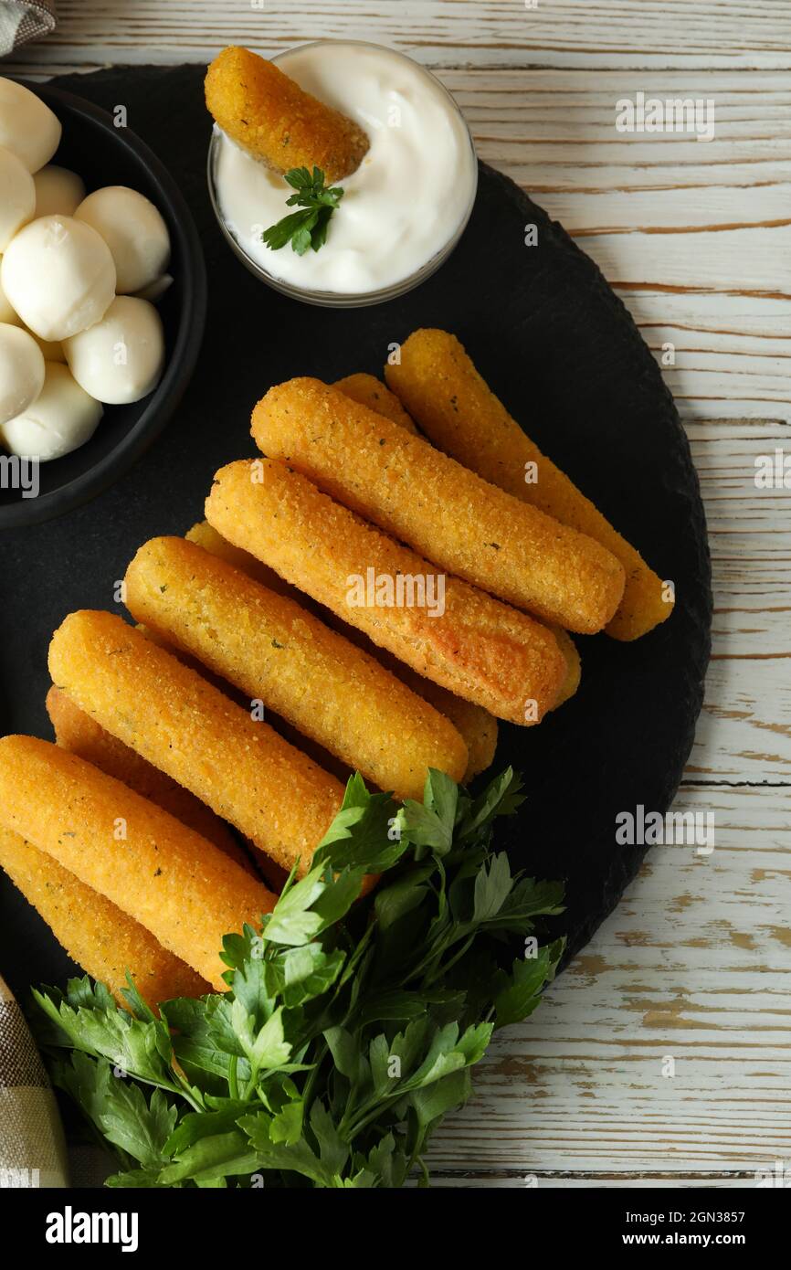 Concept of tasty food with cheese sticks on white wooden table Stock ...