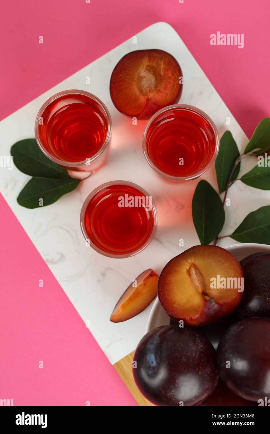 Plum brandy shots and ingredients on pink background Stock Photo - Alamy