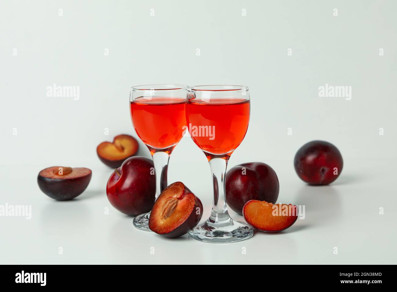 Plum brandy shots and ingredients on white background Stock Photo - Alamy