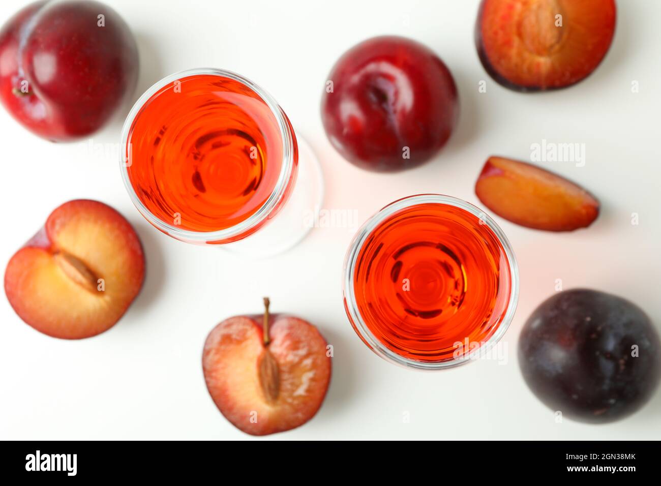 Plum brandy shots and ingredients on white background Stock Photo - Alamy