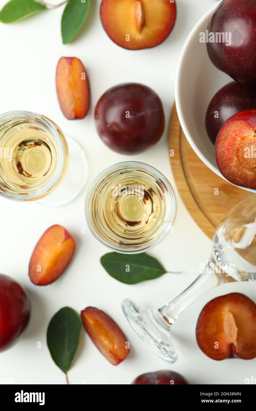 Plum vodka shots and ingredients on white background Stock Photo - Alamy