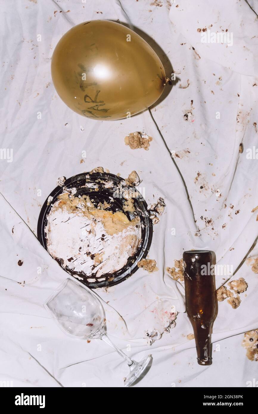 From above smashed cake for birthday celebration on crumple messy cloth ...