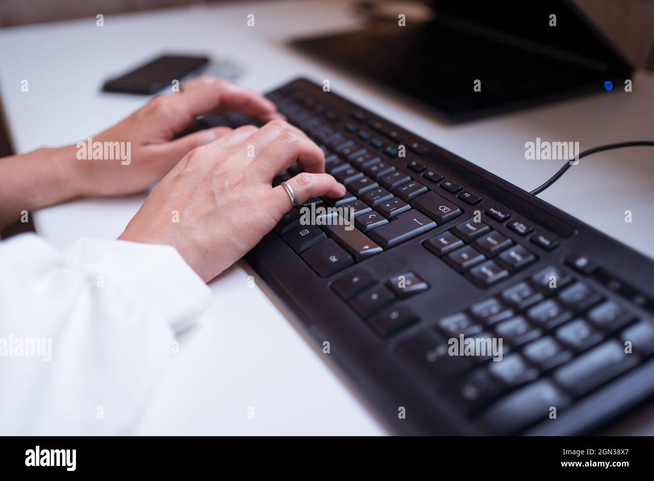 Cropped unrecognizable female working typing on computer at convenient ...