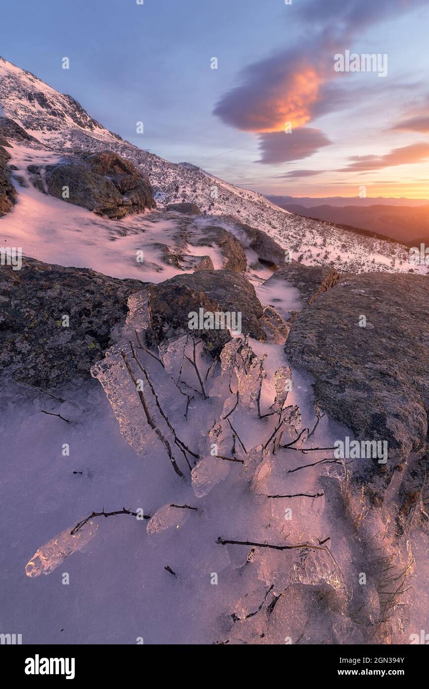 Picturesque scenery of rocky mountains covered with snow under colorful ...