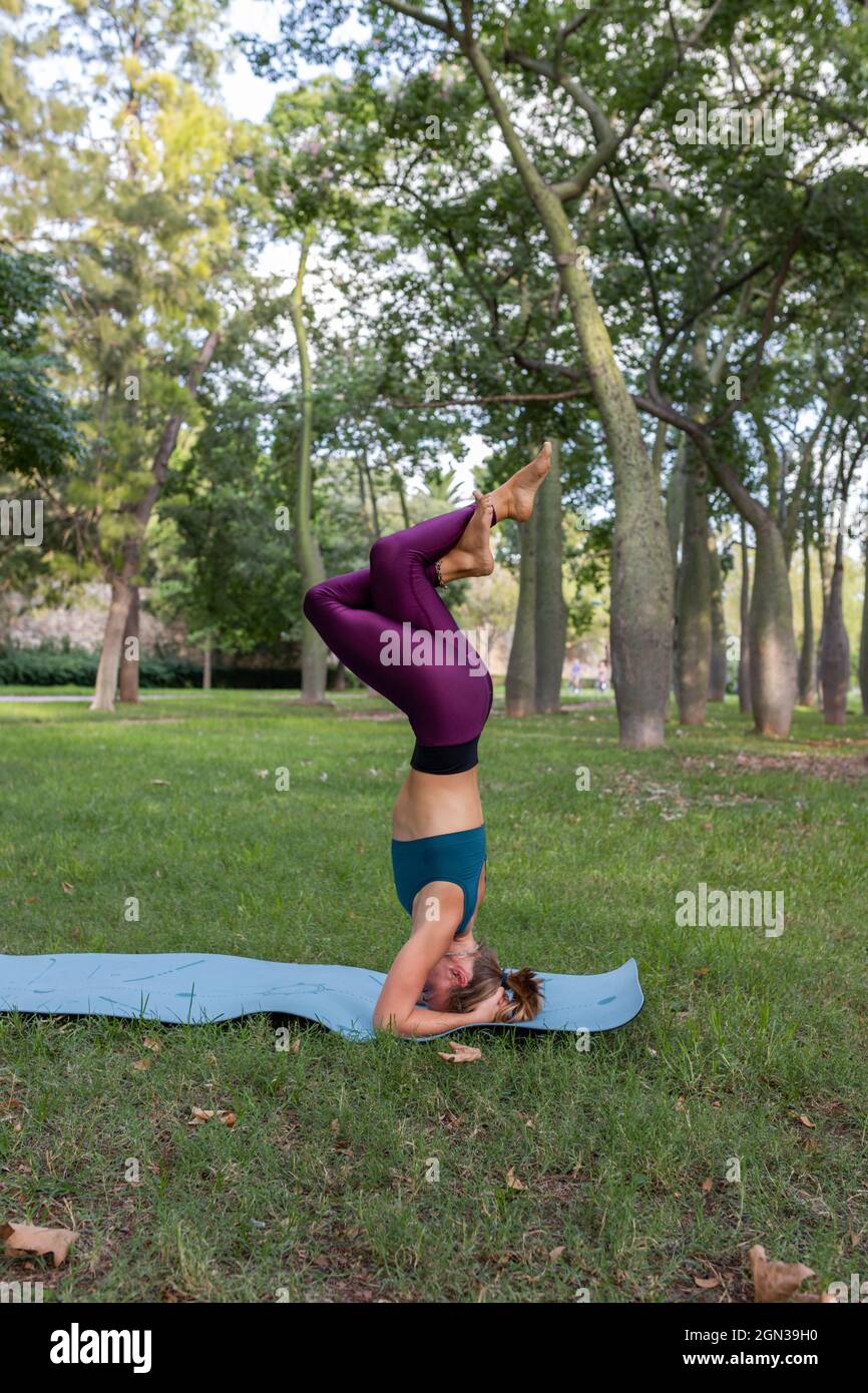 Side view of unrecognizable young female in sportswear performing ...