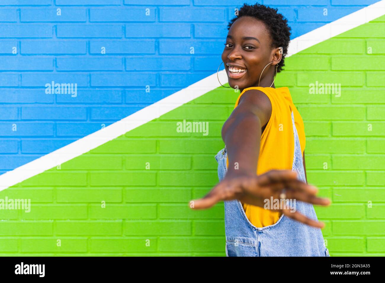 Back view of delighted African American female standing hear colorful ...