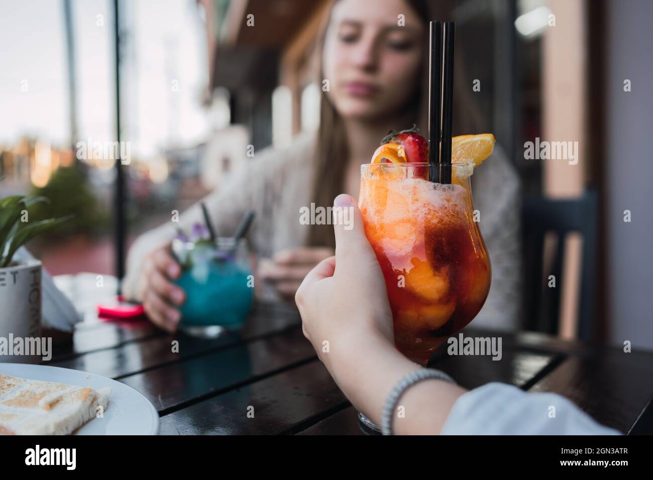 Crop content best female friends with tasty beverages in street ...