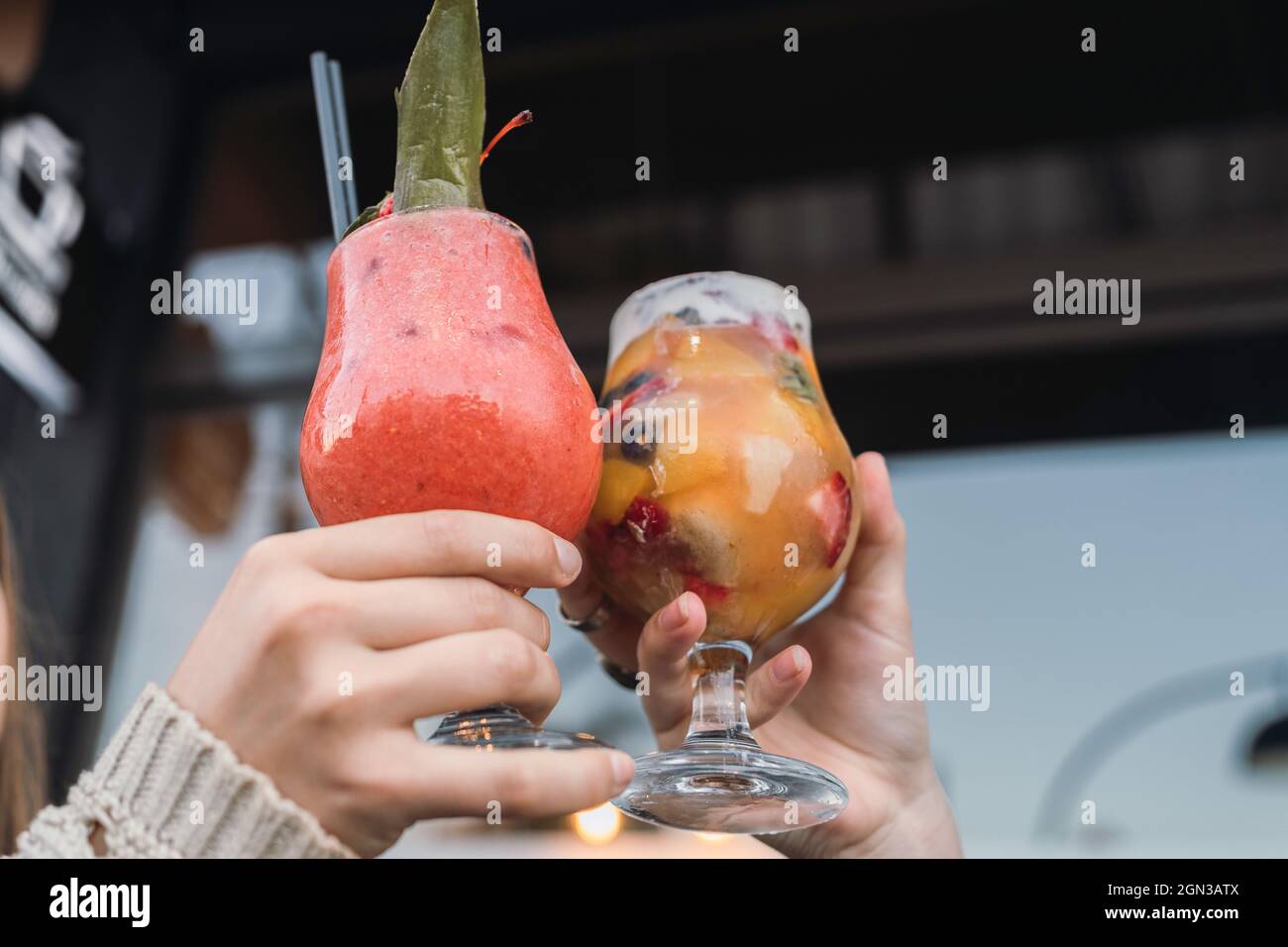 Crop unrecognizable best female friends clinking glasses of tasty ...