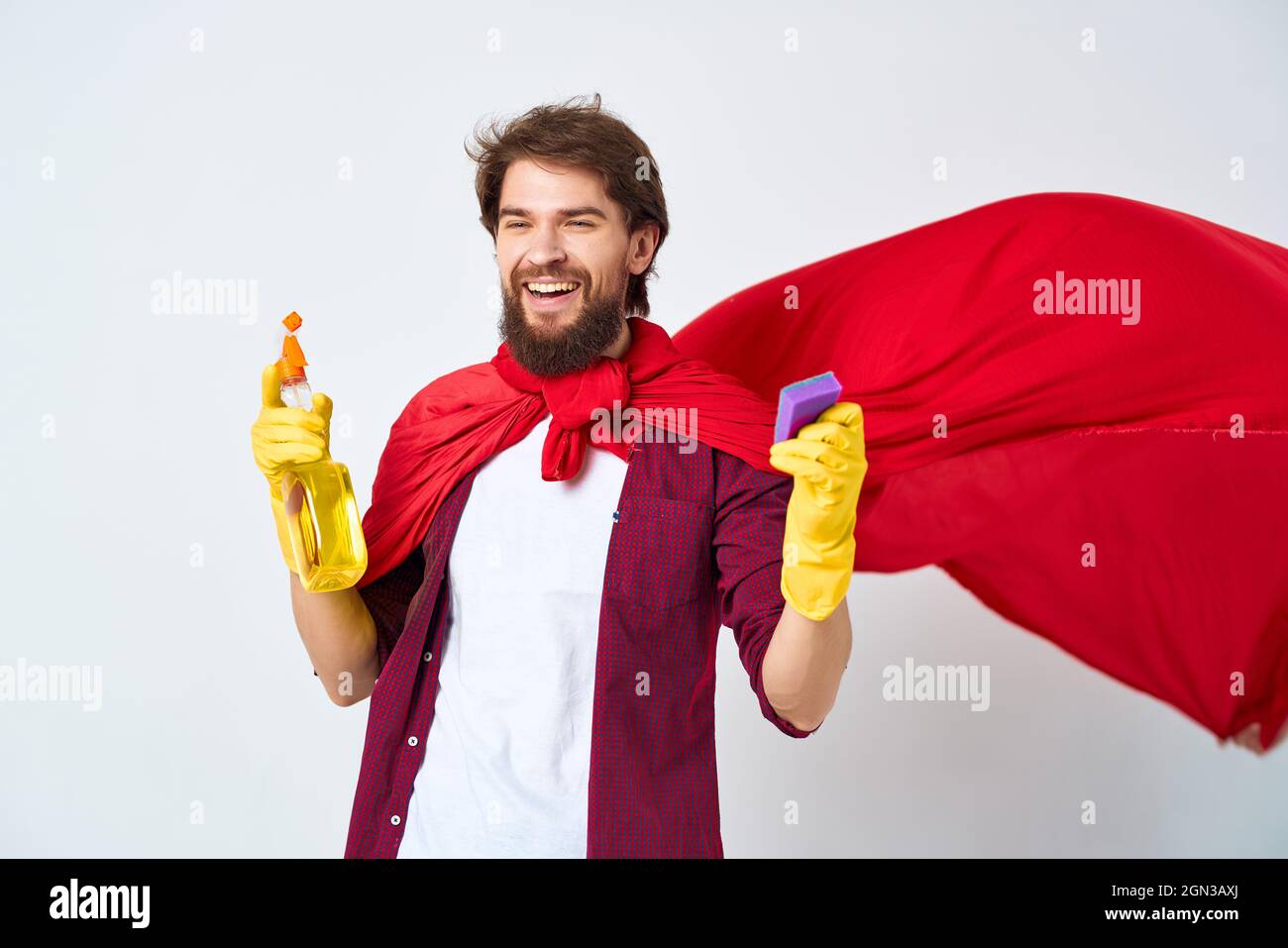 A man sitting on the floor red cloak cleaning the apartment ...