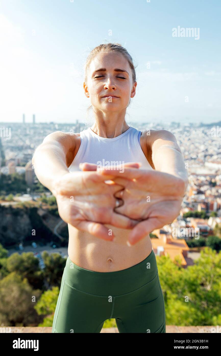 Mindful young fit female athlete in sportswear with closed eyes ...