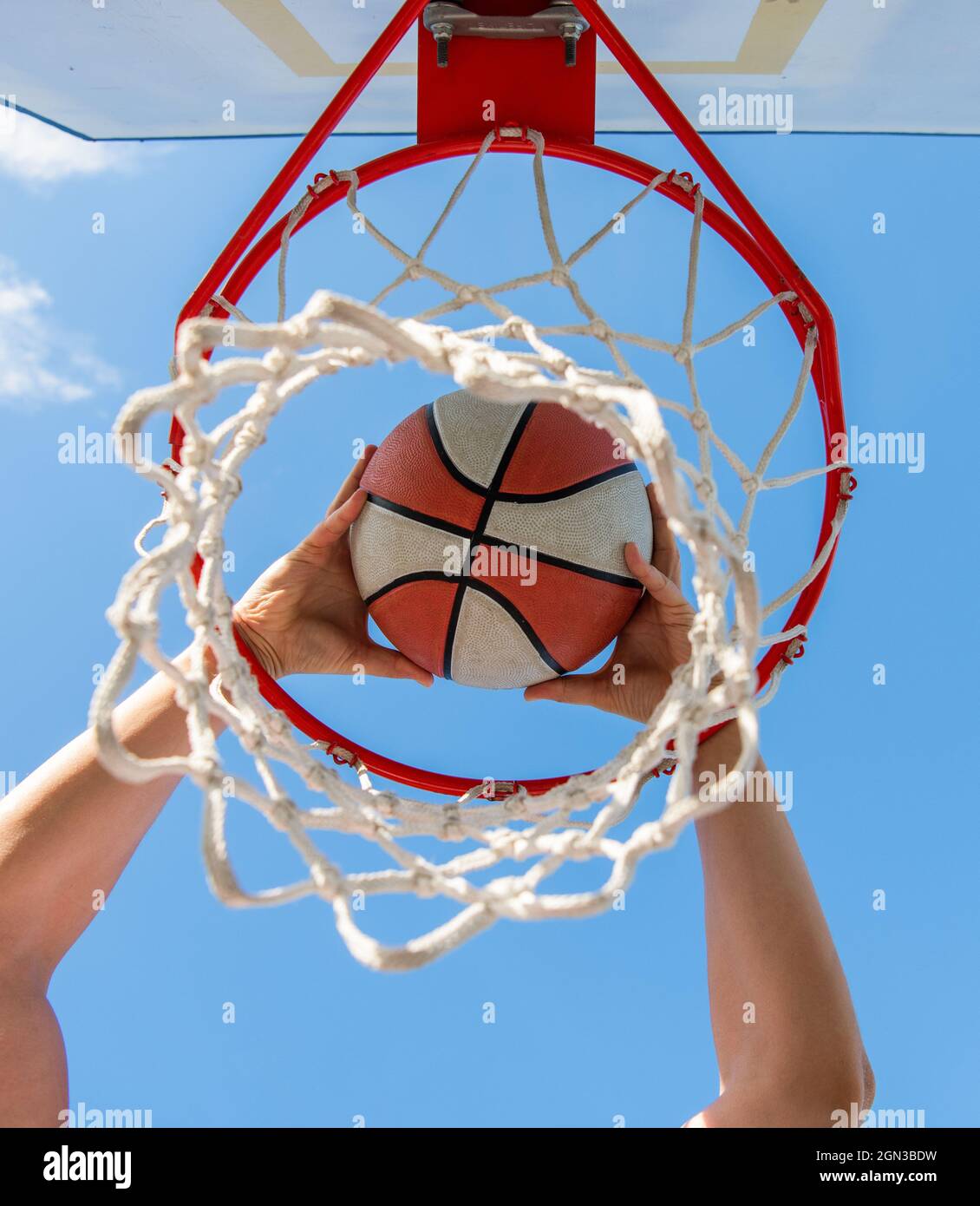 sport success. scoring while basketball game. ball goes through basket ...