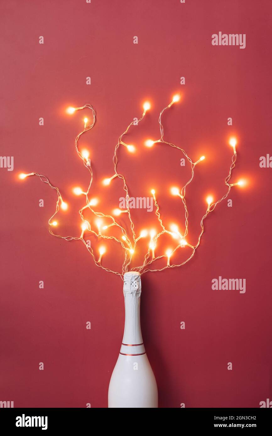 Champagne bottle with sparkling eruption of Christmas lights spewing ...