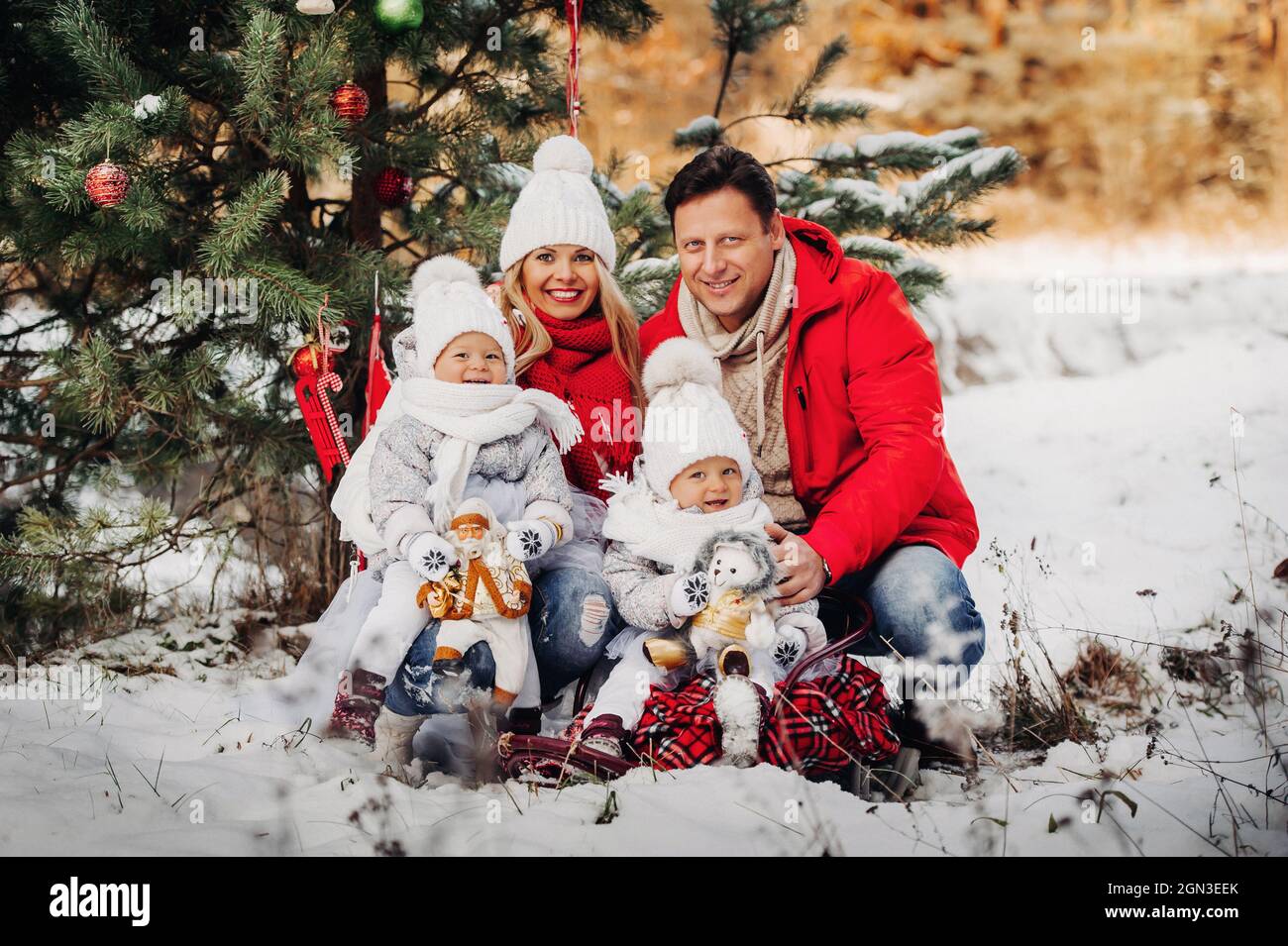 A large family with children at the Christmas tree on the street Happy ...