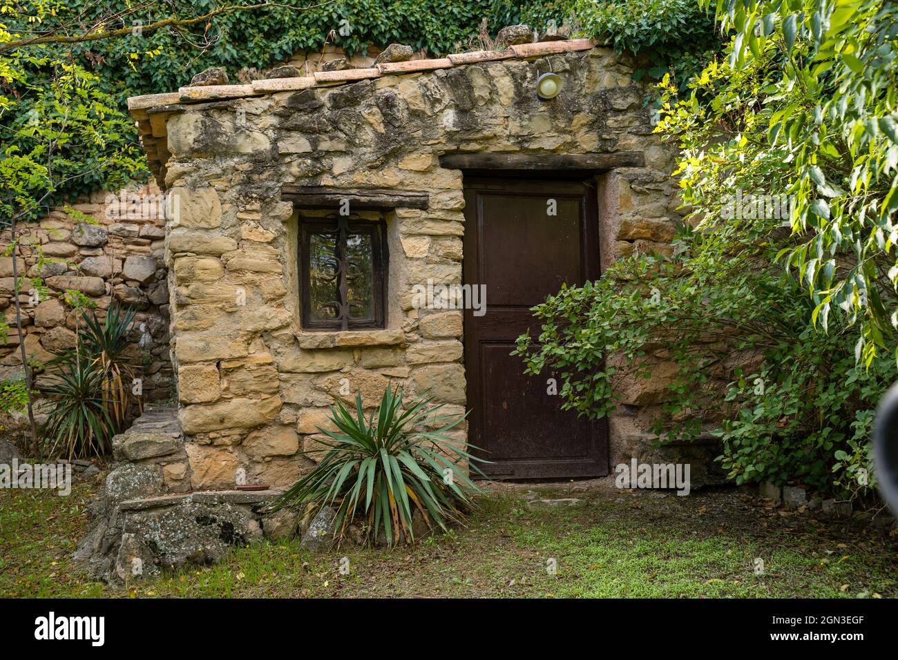medieval stone house surrounded by picturesque garden in the middle of ...