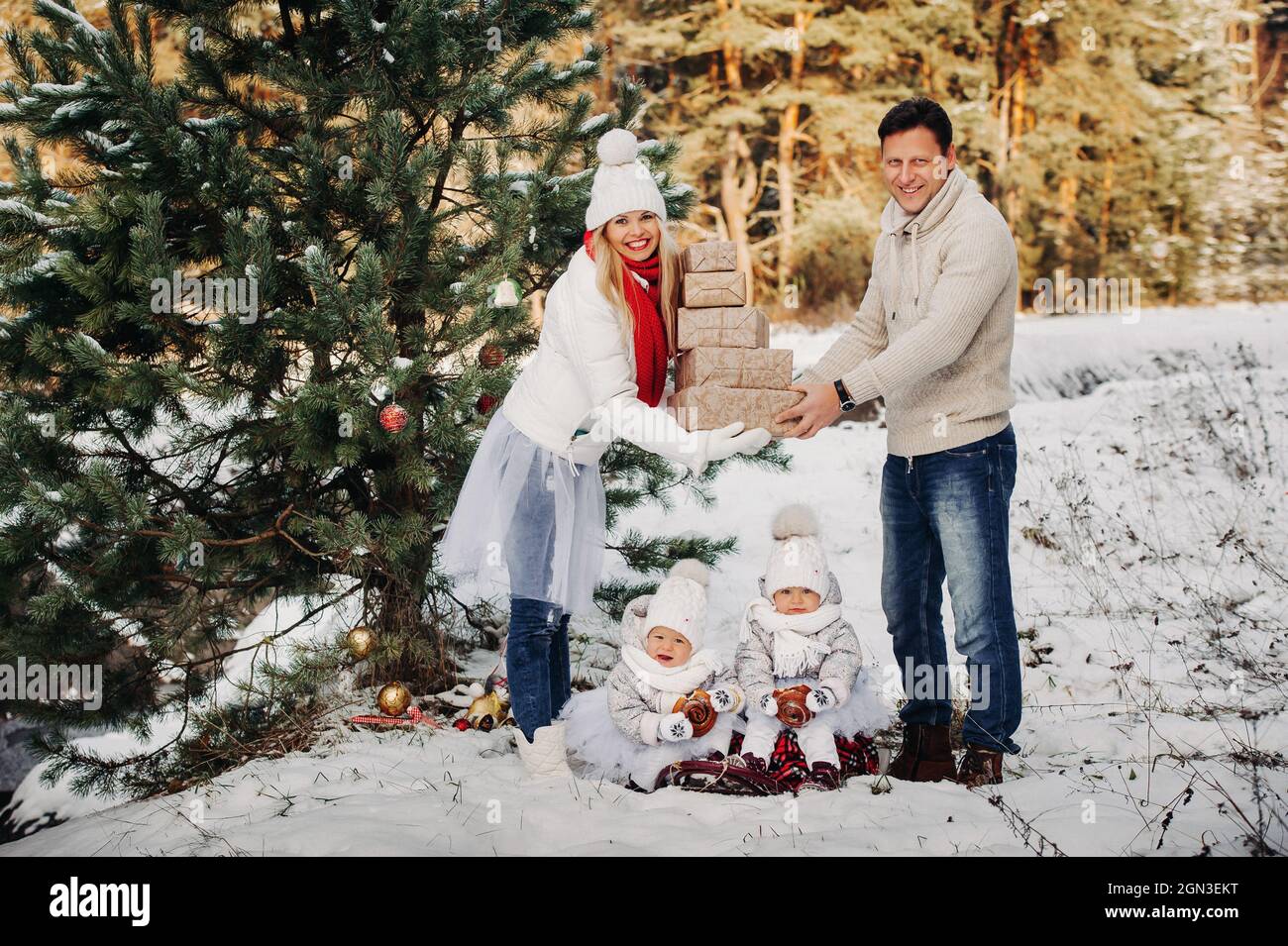 A large family with children at the Christmas tree on the street Happy ...