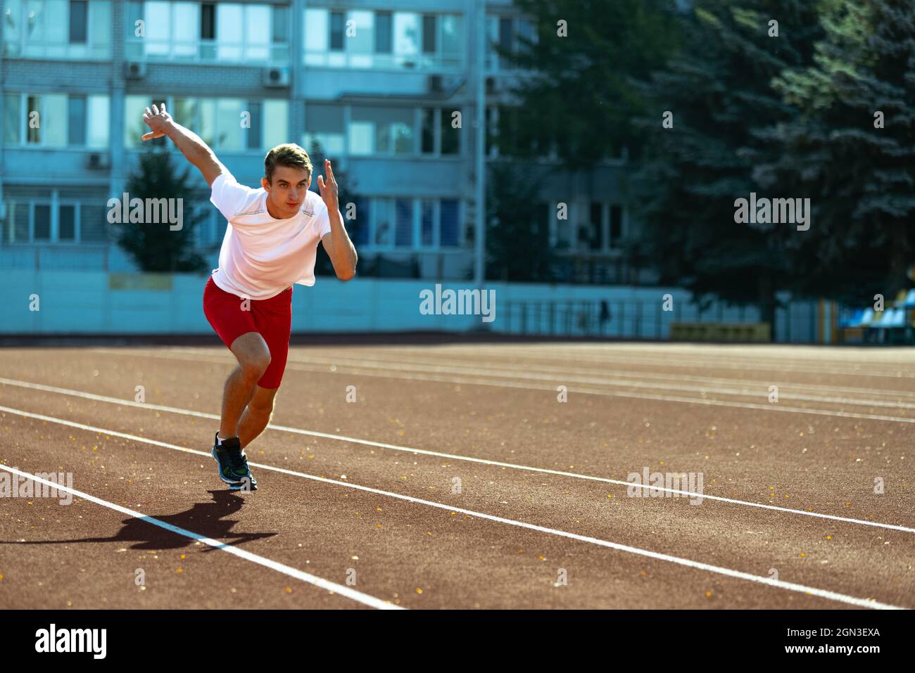Young Caucasian man, male athlete, runner practicing alone at public ...