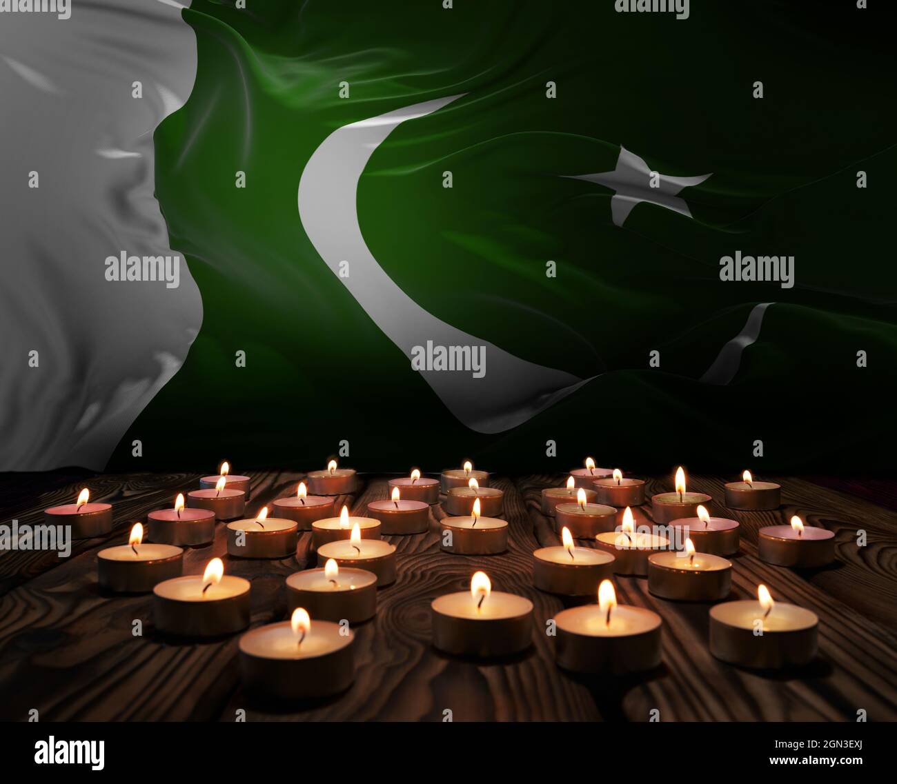 Mourning candles burning on Pakistan national flag of background ...