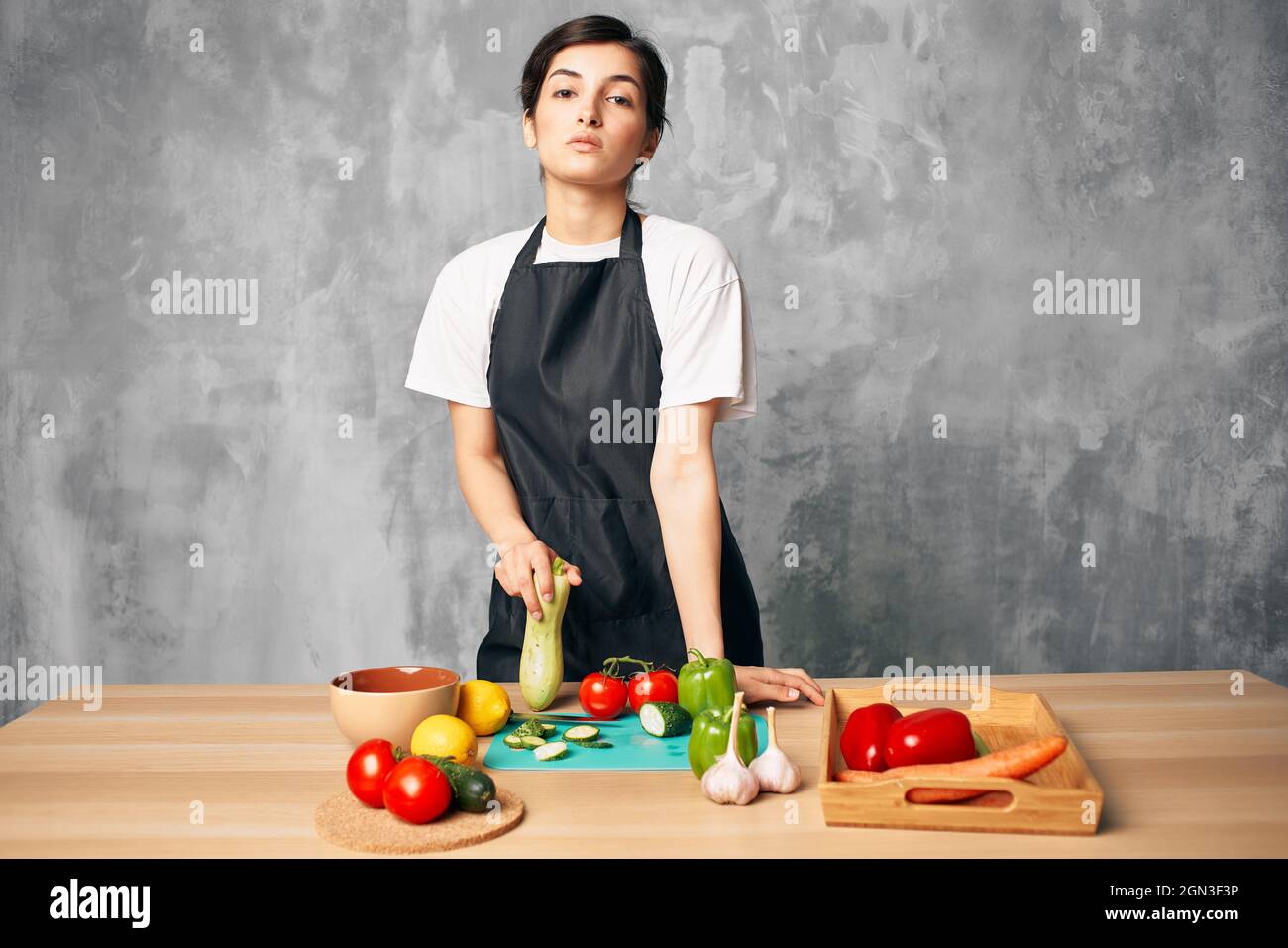 Woman in black apron Cooking healthy eating diet Stock Photo - Alamy