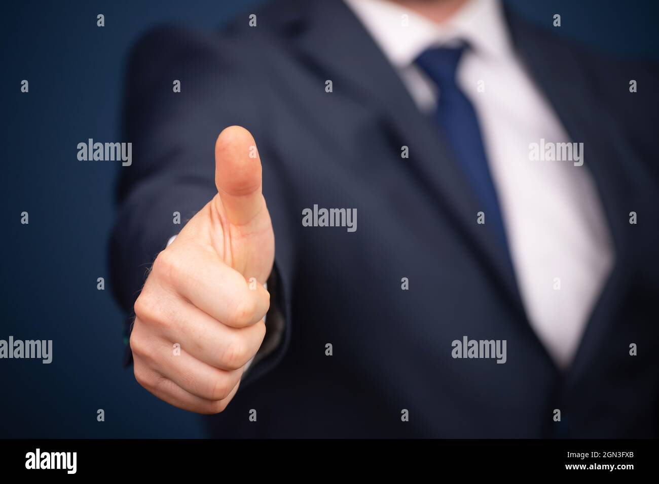 Positive business man gesturing Ok sign Stock Photo - Alamy