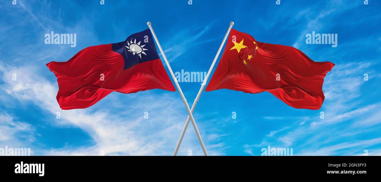 flags of China and Taiwan waving in the wind on flagpoles against sky ...