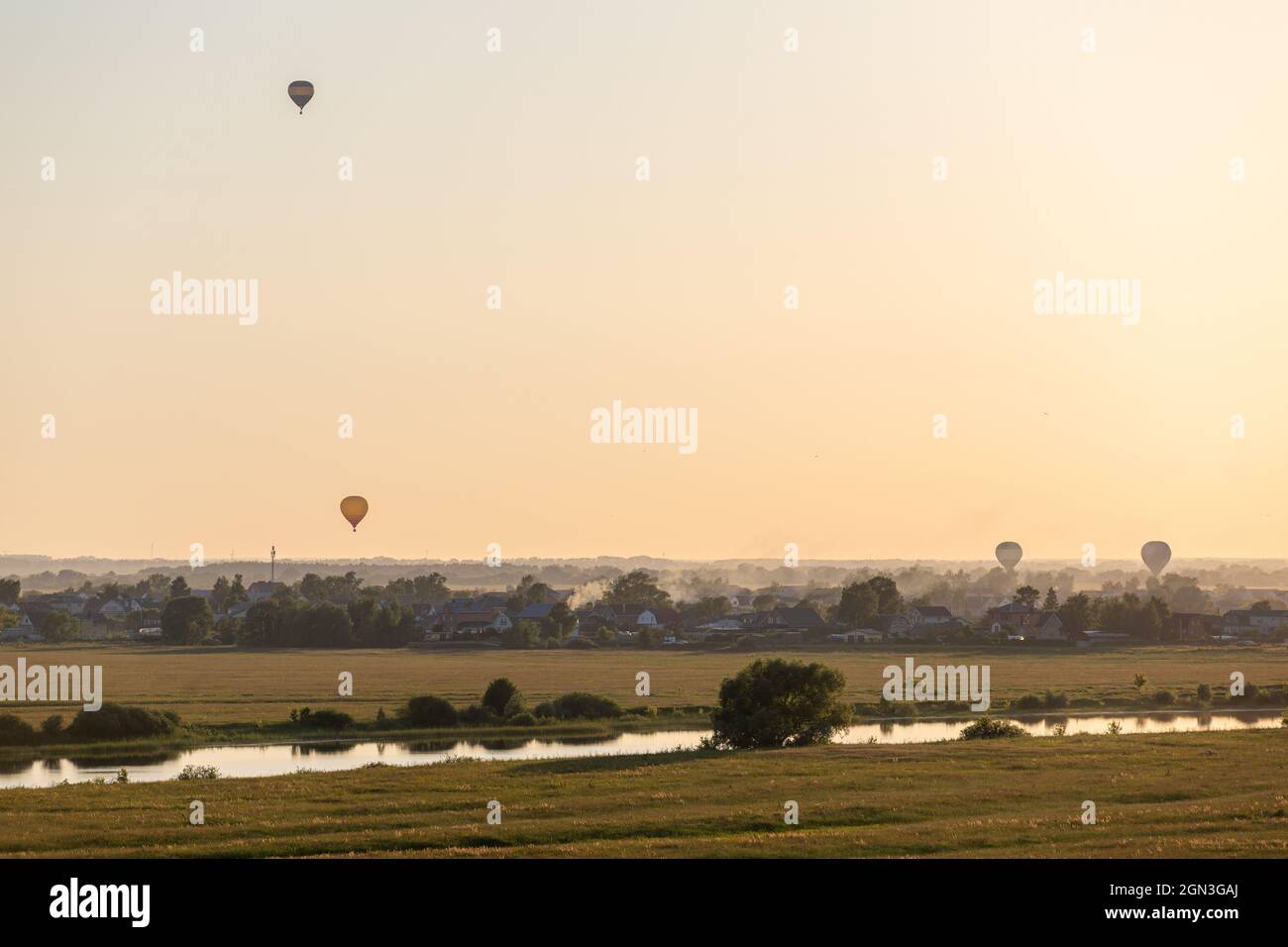Colorful hot air balloons soar in the sky at dusk or dawn. Flight over ...