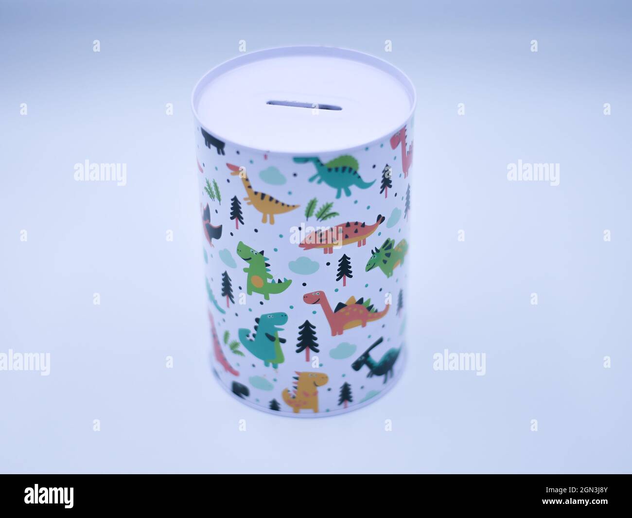 Closeup of the money box with dinosaurs pictures isolated on light ...