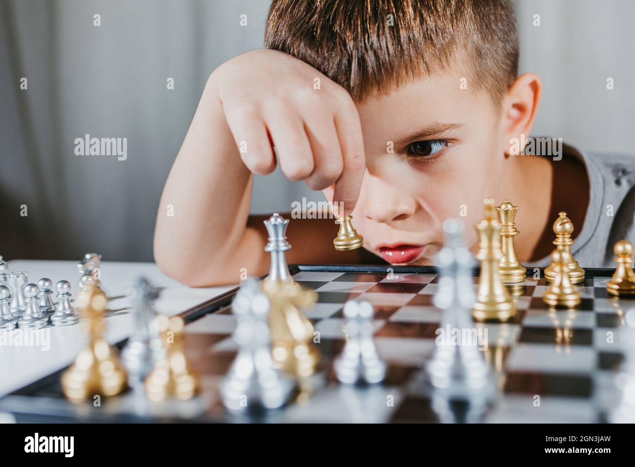 Smart child playing chess in his room at home Stock Photo - Alamy