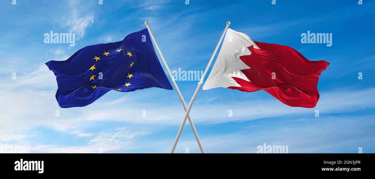 flags of European Union and Bahrain waving in the wind on flagpoles ...