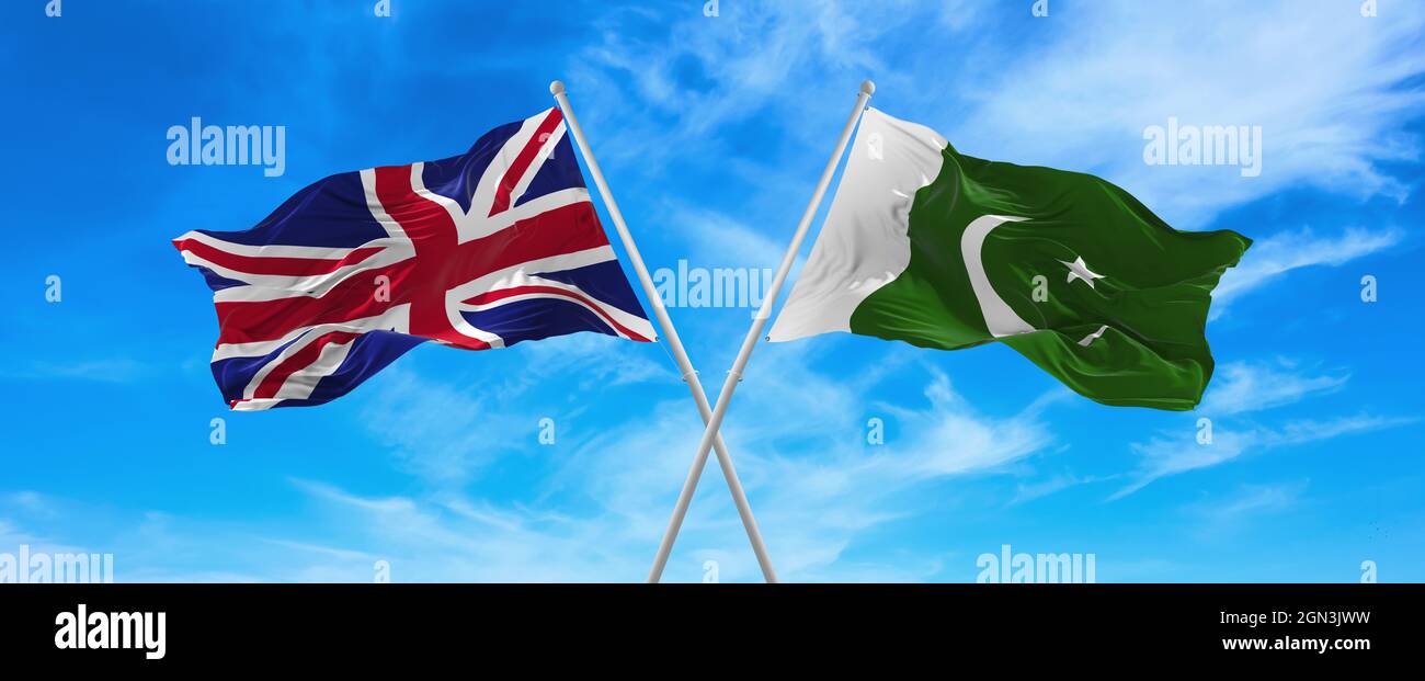 flags of great Britain and Pakistan waving in the wind on flagpoles ...