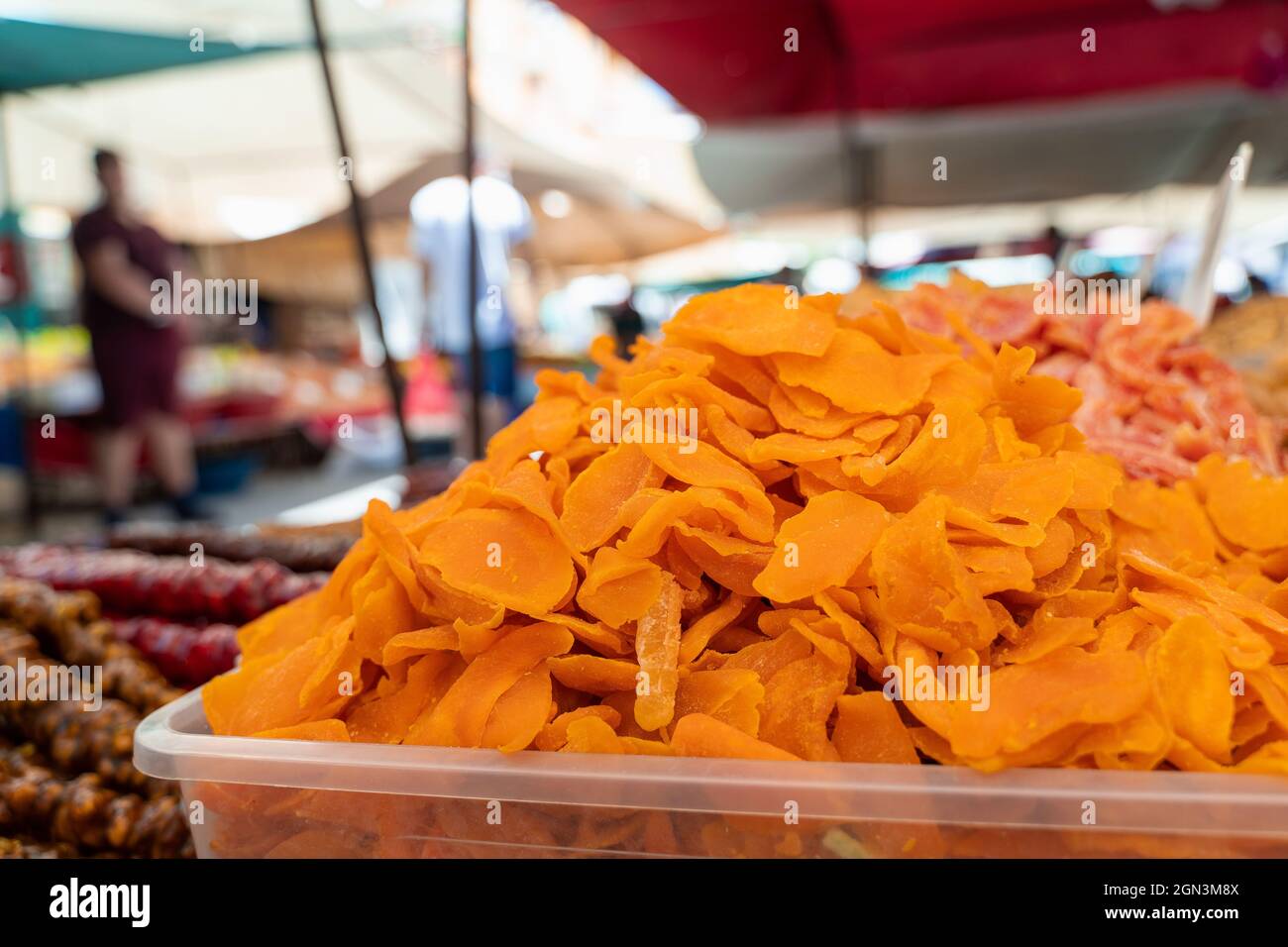 Dried mango on background of market. Dried candied fruits sold in ...