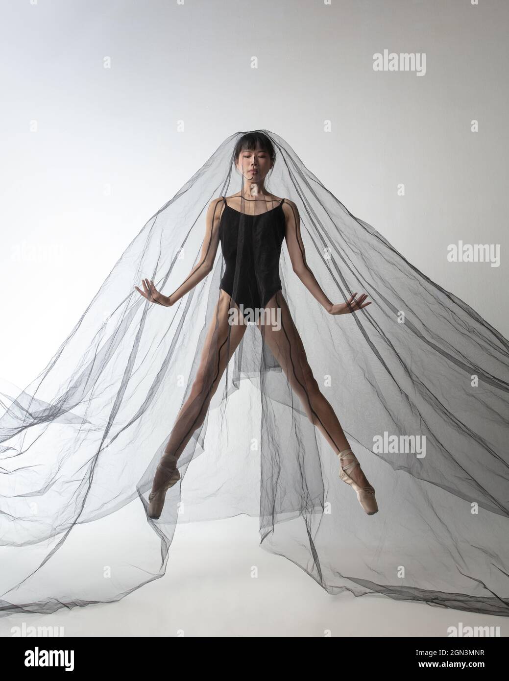 Portrait of young adorable Japanese ballerina dancing with transarent ... Portrait of young adorable Japanese ballerina dancing with transarent ...