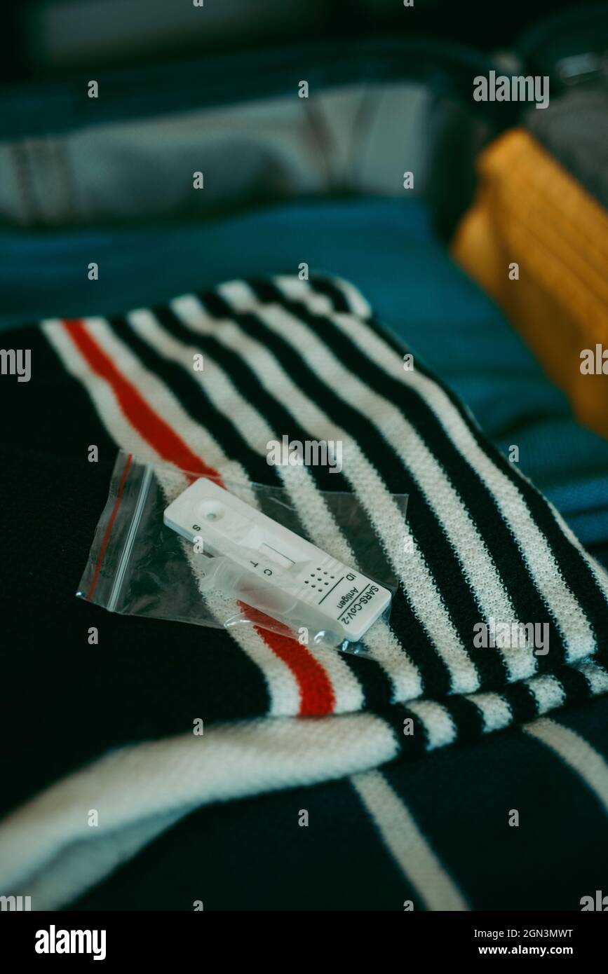 a covid-19 antigen diagnostic test kit in a suitcase, packed with ...