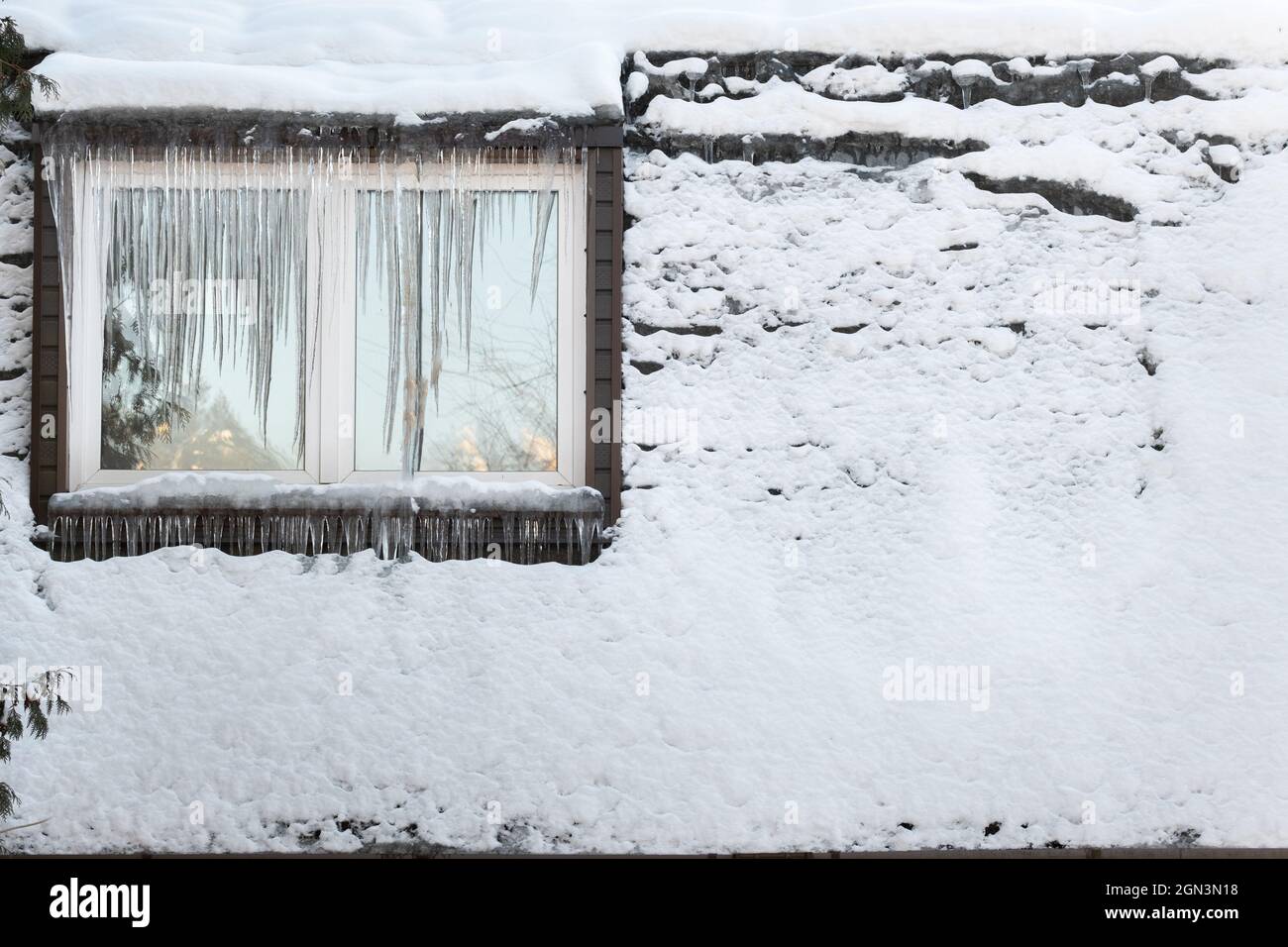 Icicles on the window of the house on a frosty day Stock Photo - Alamy