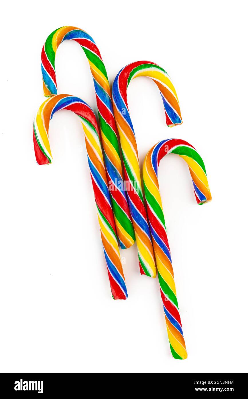Rainbow colored candy cane isolated on white background Stock Photo - Alamy