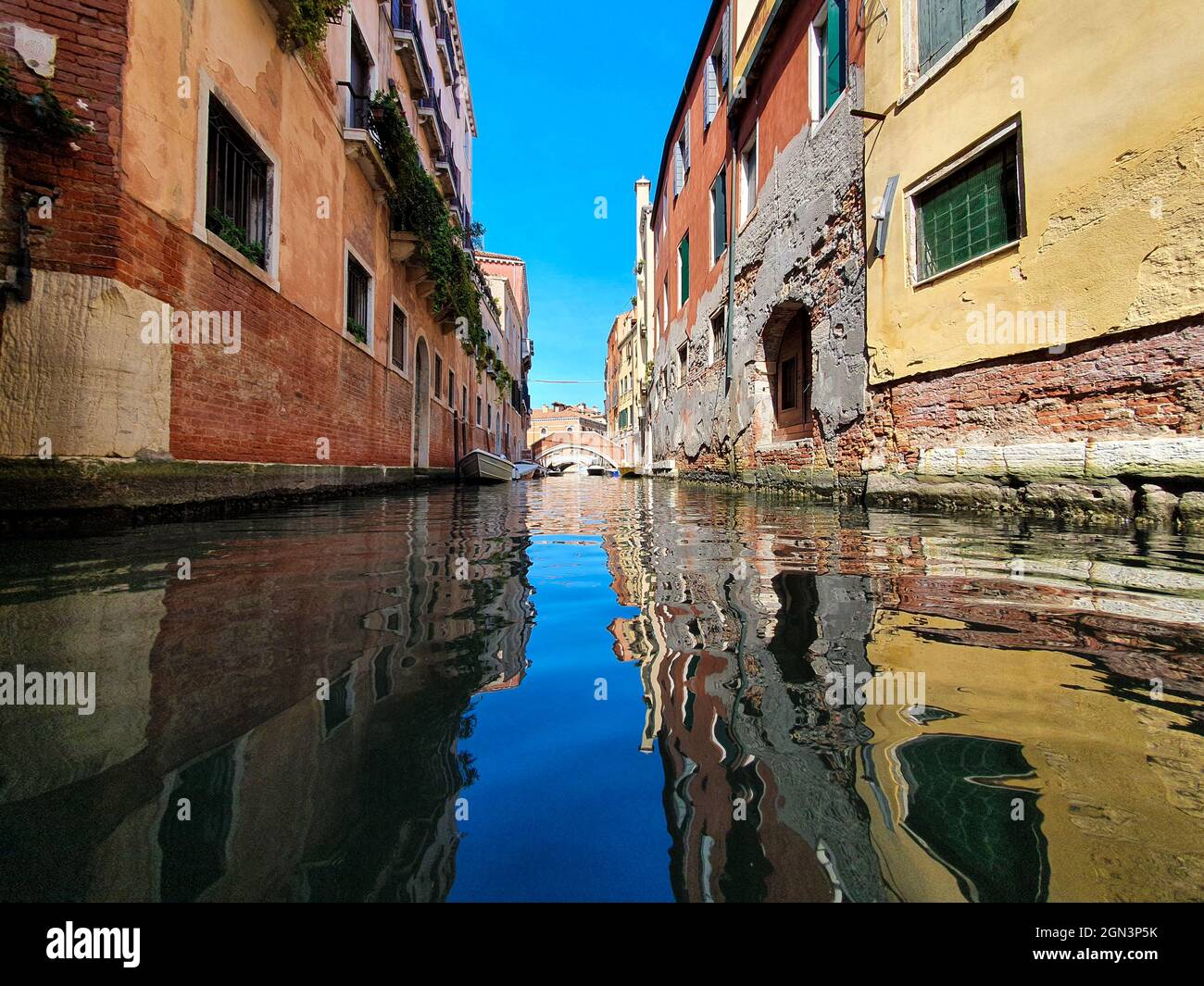 A water level photo taken on a narrow empty canal in venice Stock Photo ...