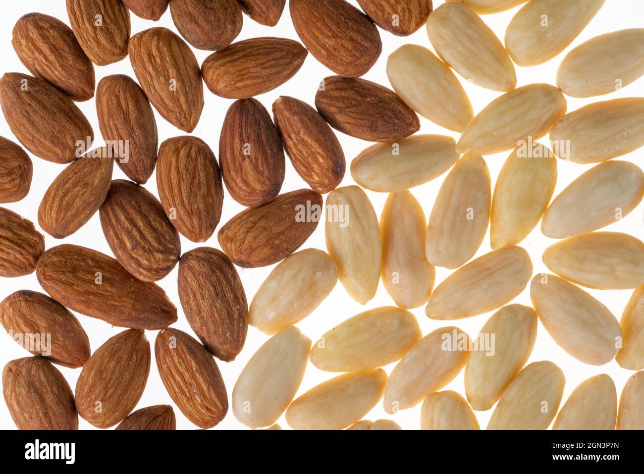 Shelled almonds and peeled almonds isolated on white, pattern in top ...