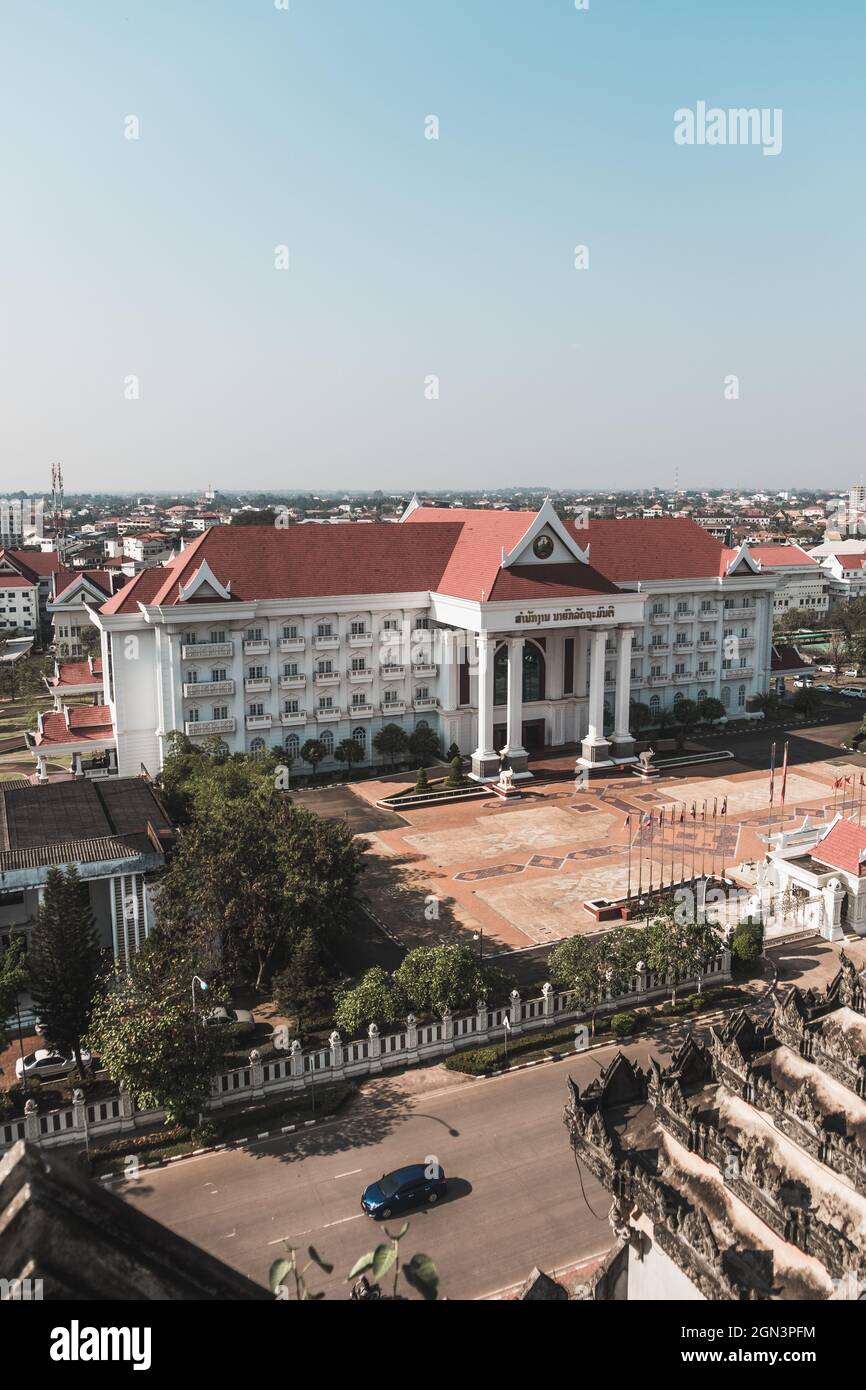 Square in the capital of Laos. White historic building with columns ...