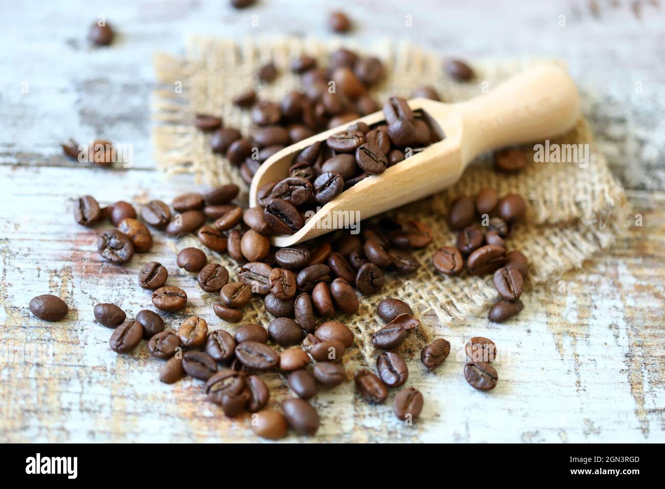 Coffee beans in a wooden spatula. Roasted coffee beans Stock Photo - Alamy
