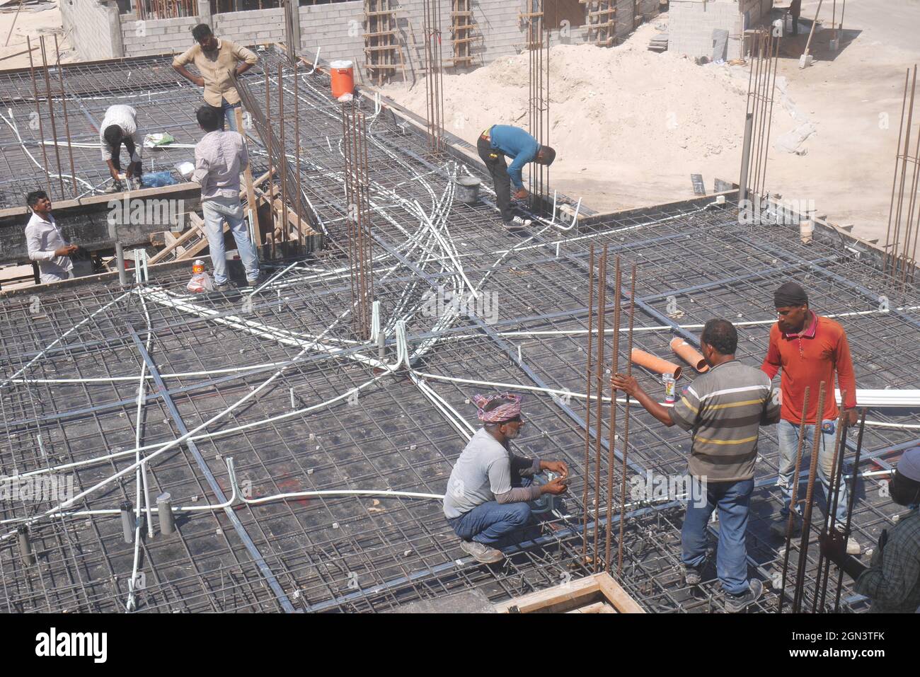 Asian construction workers working on a building, Kingdom of Bahrain ...