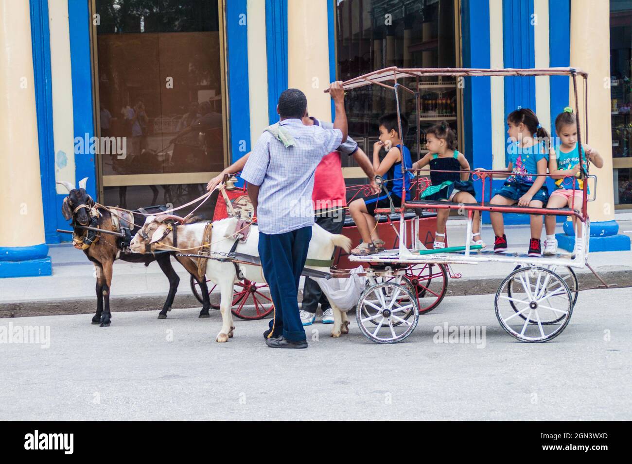 BAYAMO, CUBA - JAN 30, 2016: Kids enjoy a goat ride on Cespedes square ...