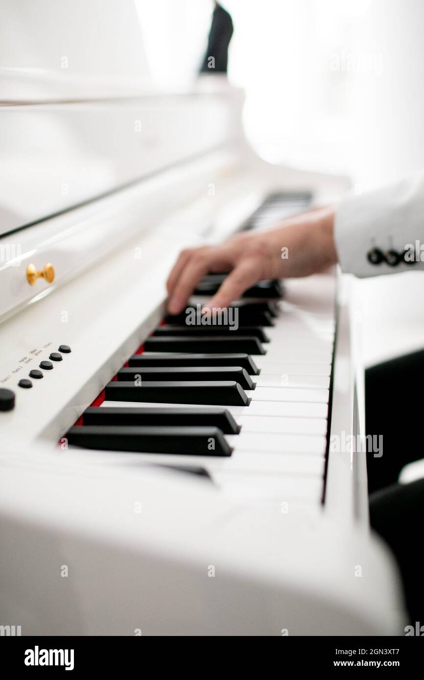 Close up of man hands piano playing. Male pianist hands on grand piano ...