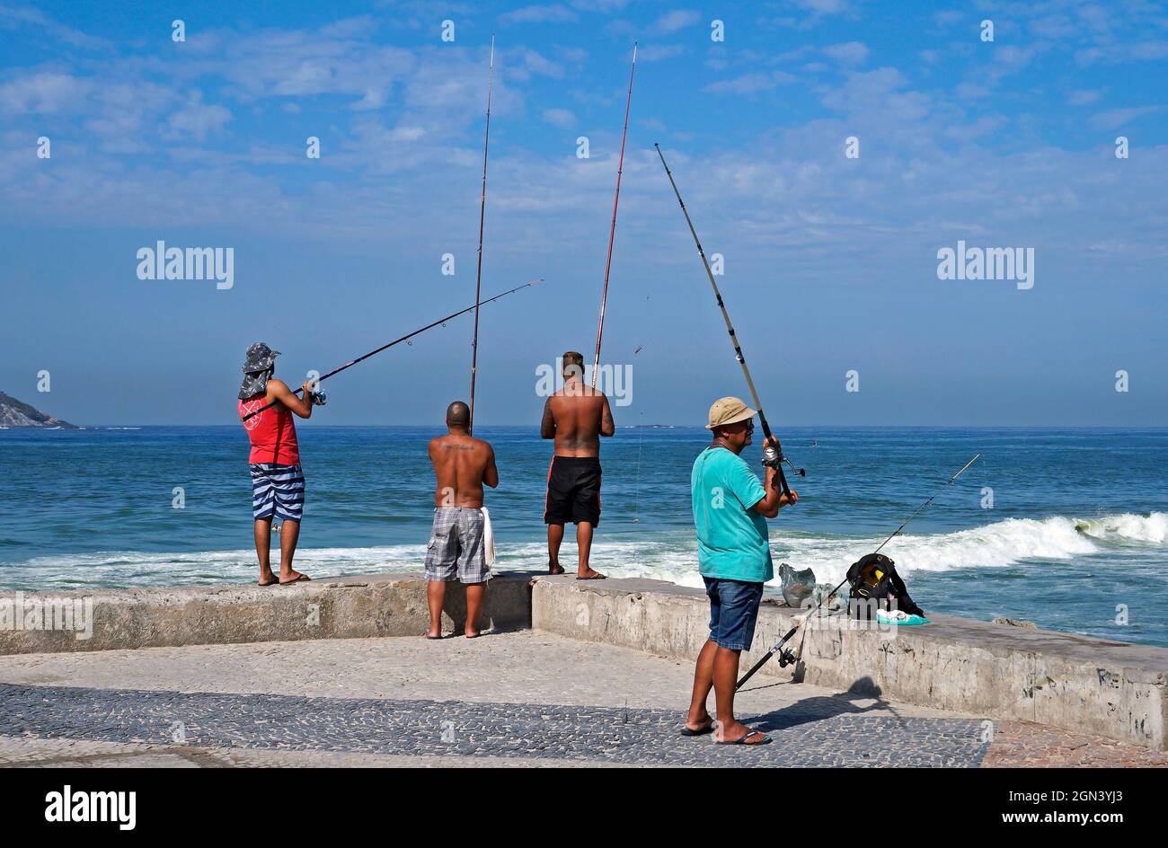 RIO DE JANEIRO, BRAZIL - MARCH 25, 2017: Men fishing at Barra da Tijuca ...